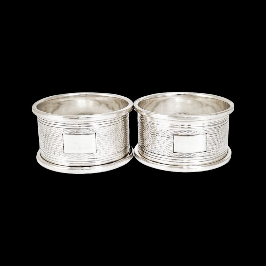 Sterling silver pair of engine-turned napkin rings with vacant ...